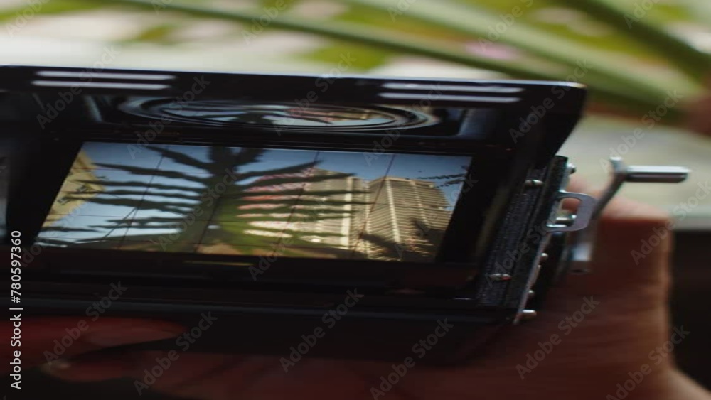 Vertical shot of unrecognizable photographer using old camera to film ...