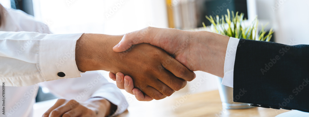 hand of client and banker shaking hands on the meeting table after ...
