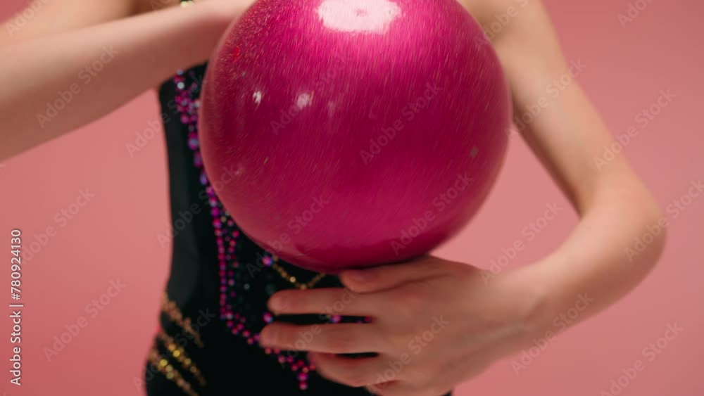 Cropped shot female hands rotating spinning gymnastic ball ...