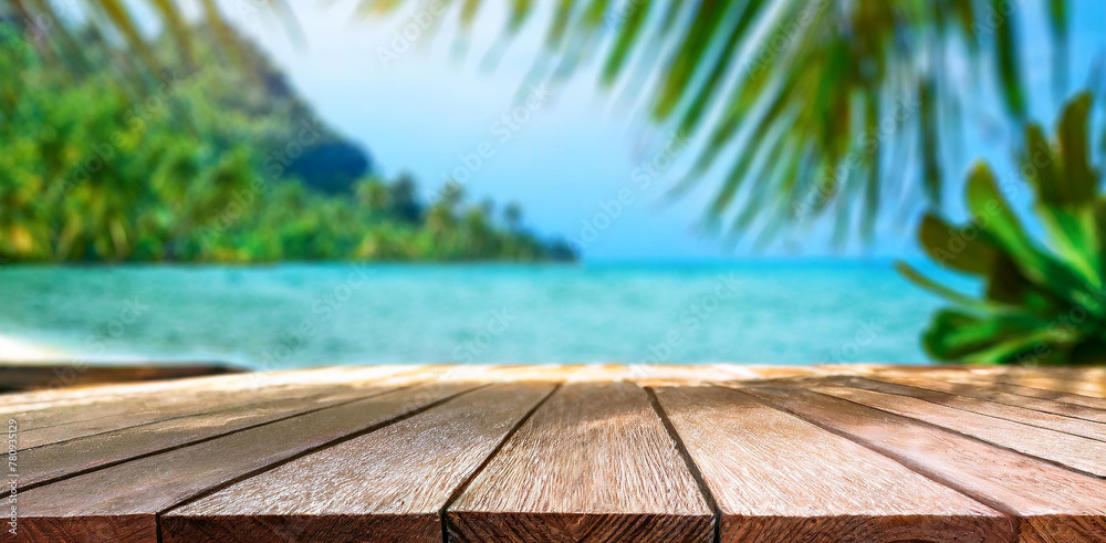 Empty wooden countertop with blurred ocean shore, palm trees, sand on ...