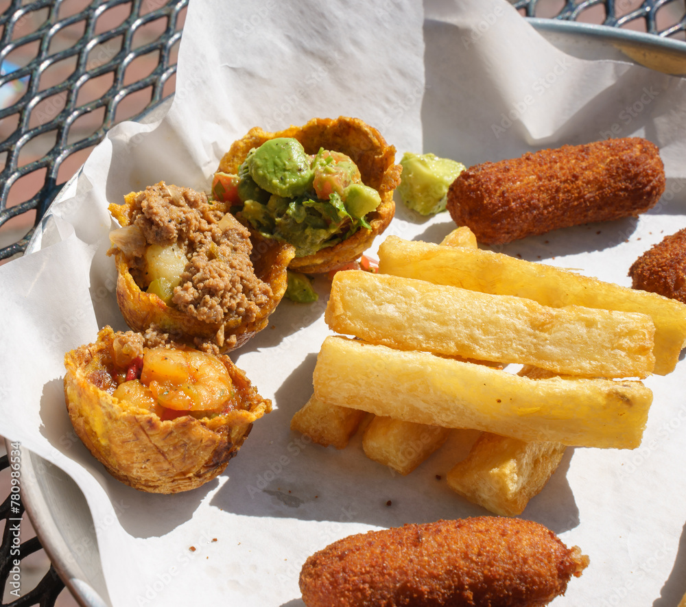A combo of Cuban appetizers named Mojioto's Sampler. It includes fried ...