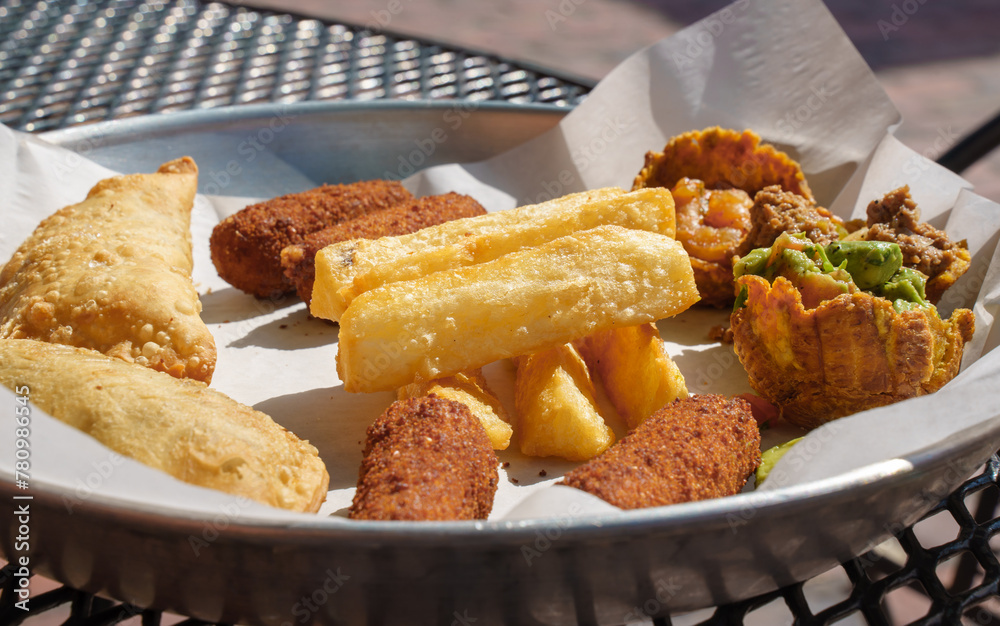 A combo of Cuban appetizers named Mojioto's Sampler. It includes fried ...