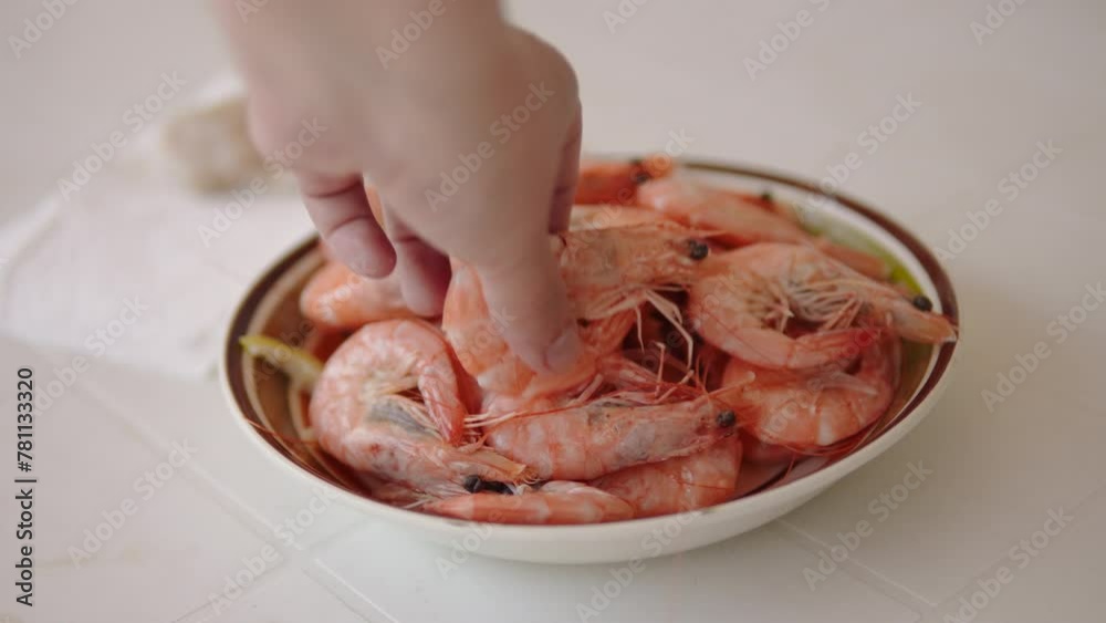 White person hands take from plate filled with fresh large boiled ...
