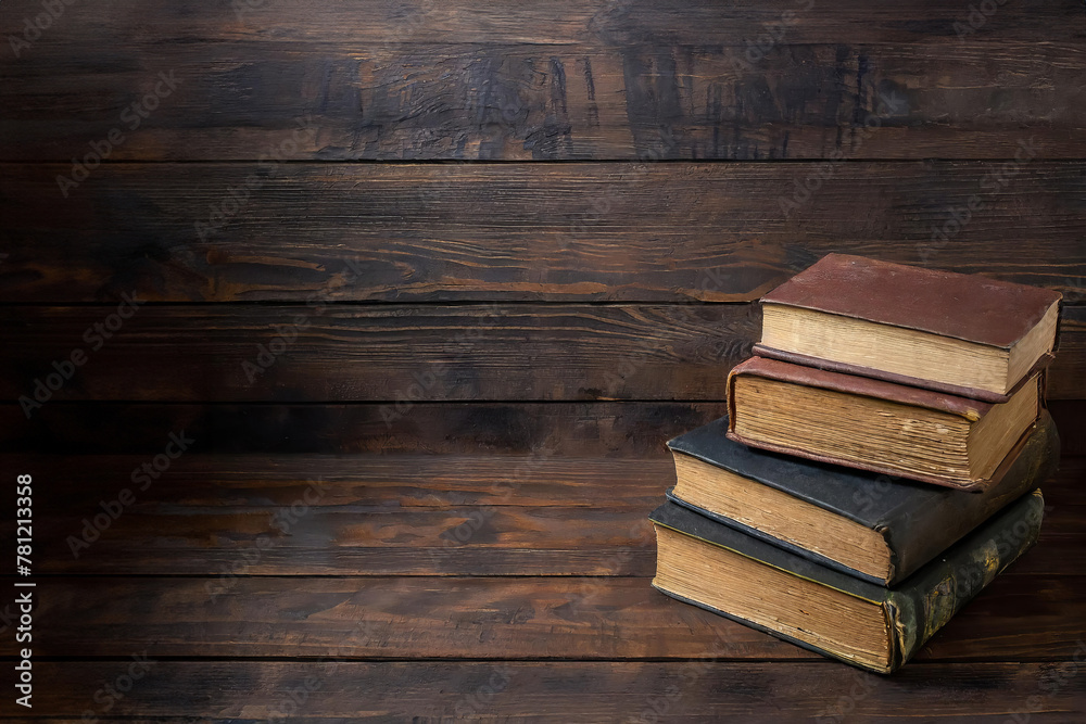 Four old books leather binding stack on top of each other dark ...