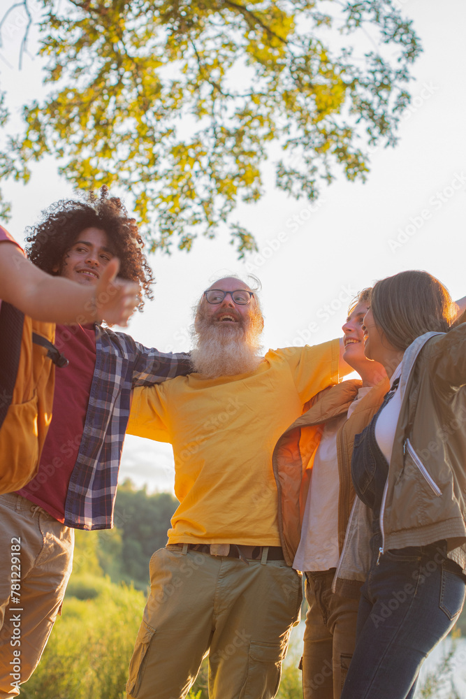 Group of people of different generations hugging each other in a circle ...