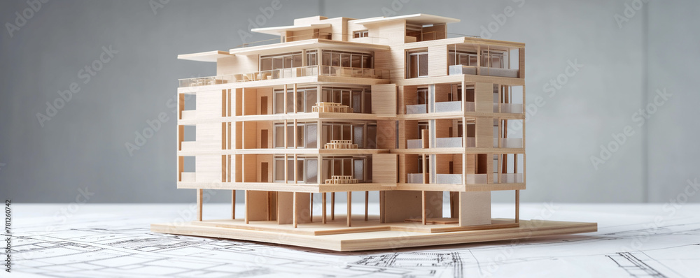 A detailed wooden architectural model of a modern multi-story apartment ...