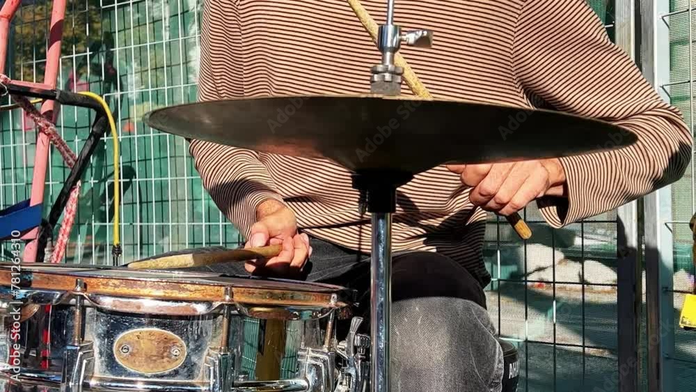 Close-up of a drummer, hands in motion, playing the cymbals and snare ...
