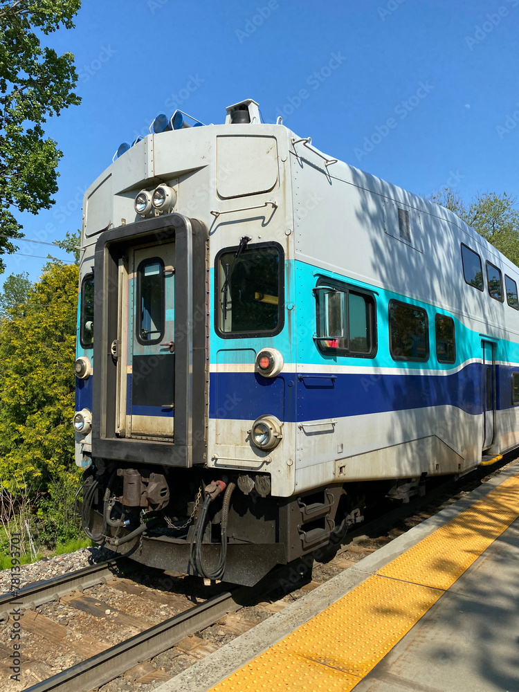 Tail end of train on the railway. City train at the station ready for departure. Suburban train ...