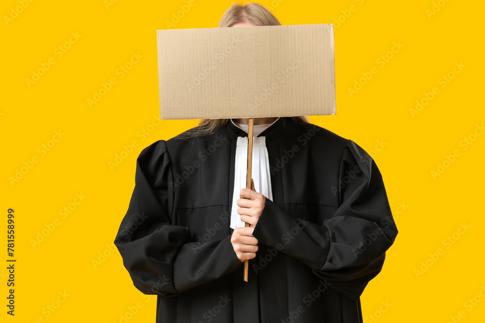 Protesting female judge holding blank placard on yellow background ...