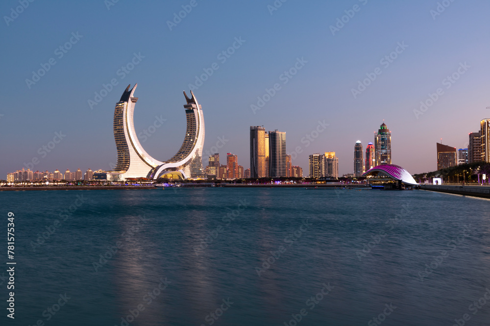 Crescent tower from Al Maha Island in Qatar, with a brightly blue sky ...