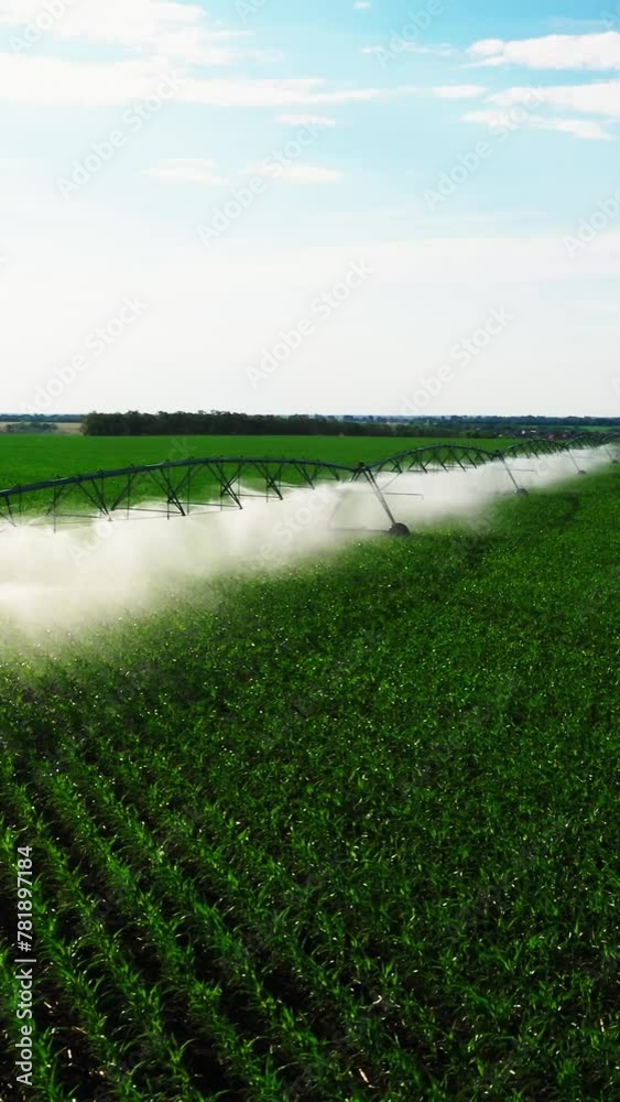 Vertical video, drone aerial view of rain cannon irrigation system on ...