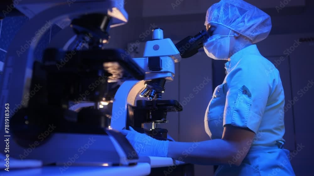 In Medical Science Laboratory: Beautiful Microbiologist Looks Under ...