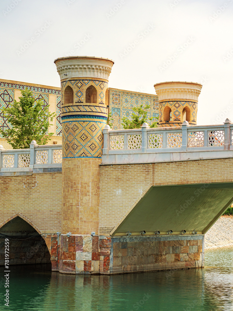 Beautiful bridge over the canal decorated with columns with traditional ...