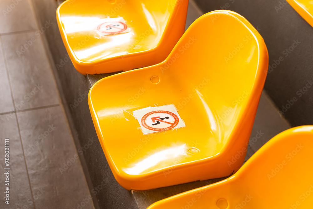 Plenty of yellow plastic seats at stadium. Bright yellow seats for fans ...