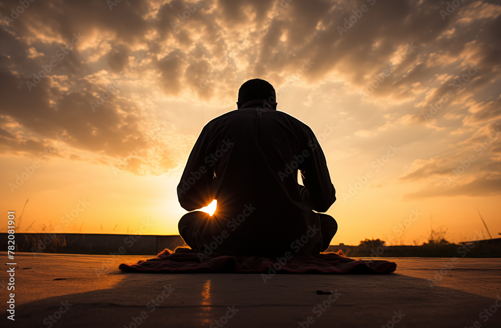 Prayer concept. Silhouette of a man in a praying pose. Set against a ...