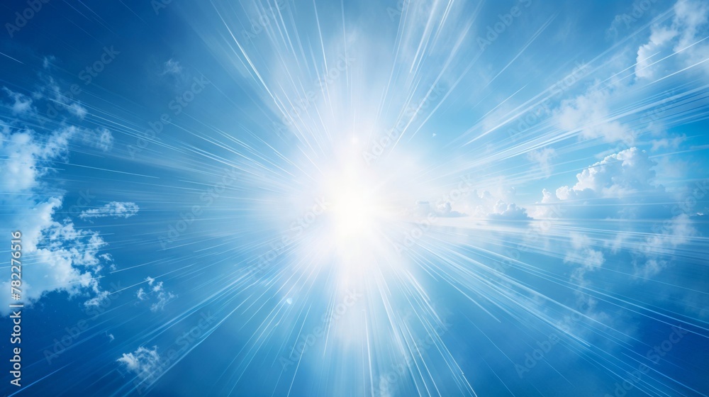 Brilliant sunburst with lens flare against a blue sky during midday ...