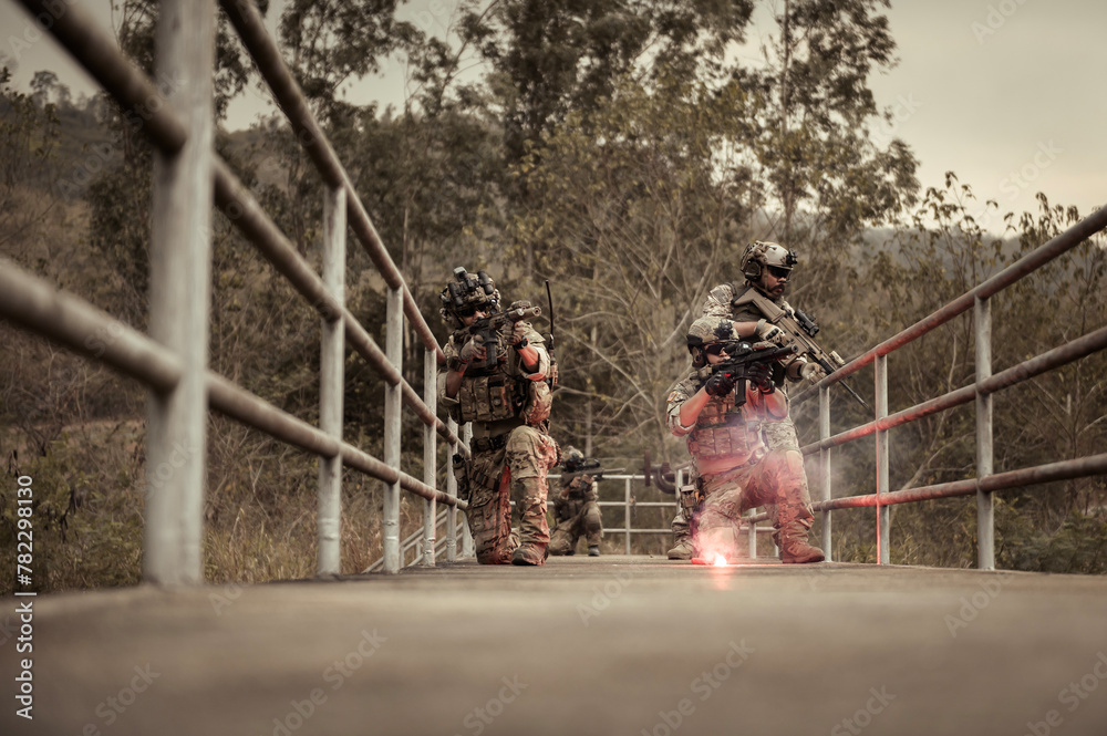 Soldiers in camouflage uniforms aiming with their rifles.ready to fire ...