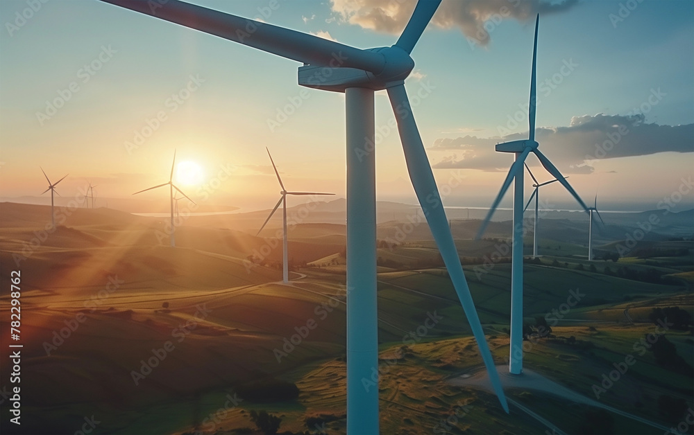 Wind energy farm illuminated by a vibrant sunset - Rows of wind ...