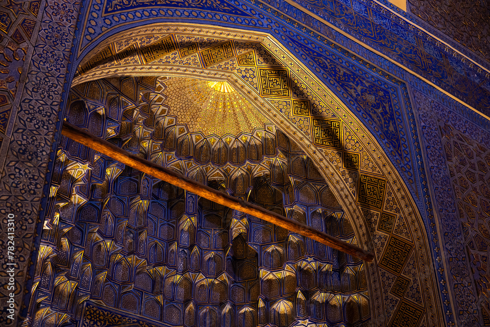 Inside the mausoleum, deep niches and diverse muqarnas decoration. Gur ...