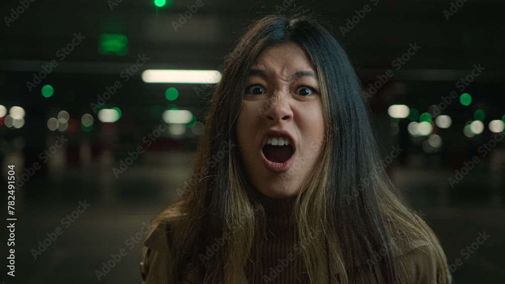 Mad angry crazy Asian korean chinese japanese girl shout in car parking ...