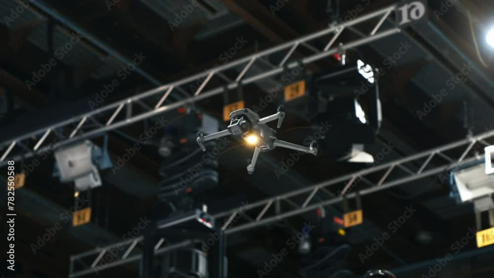 Drone flying and filming near flashing studio lights and camera ...