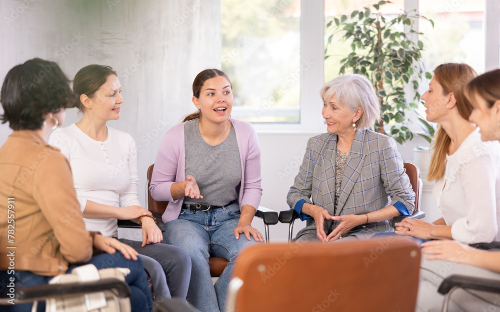 Positive young girl participating in volunteer organization talking ...