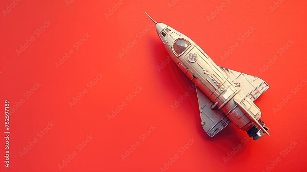 Toy space shuttle on vibrant red background, at diagonal orientation ...