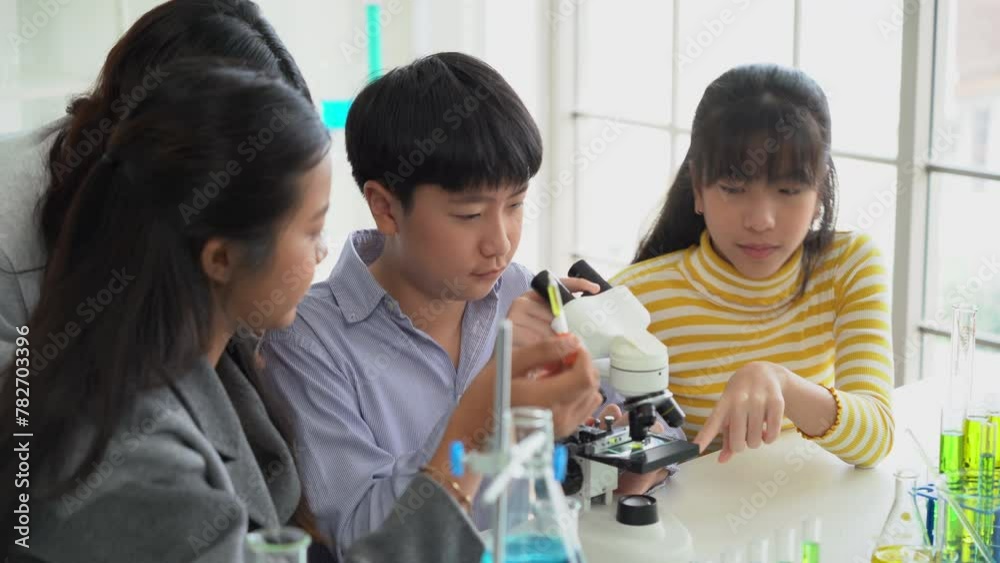 group of asian school kid pupil student looking through microscope ...