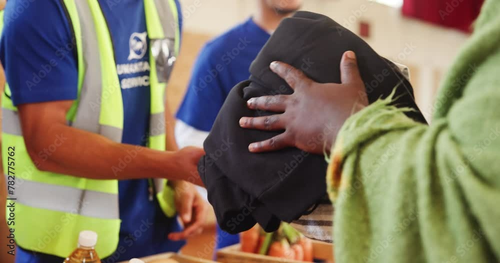 Volunteer, men and group with clothes to homeless for community service ...