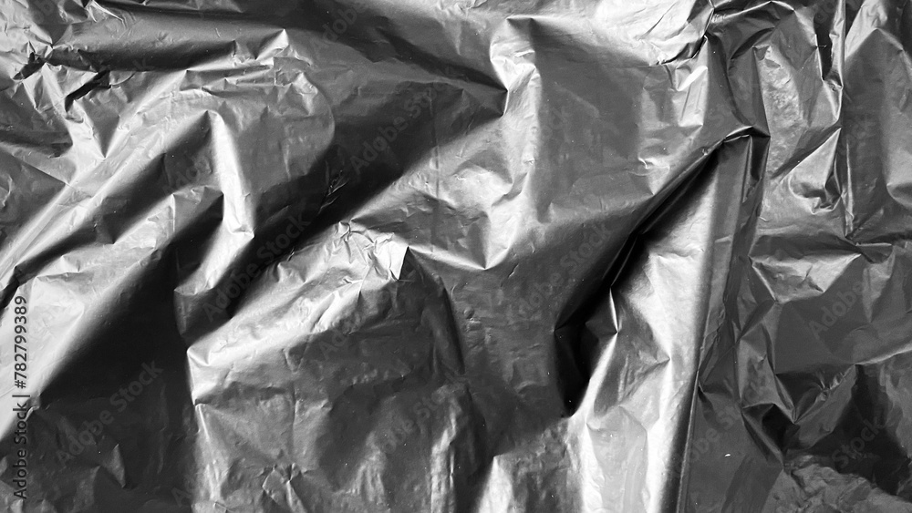 Crumpled paper and foil with black and white plastic bags, waste bin ...