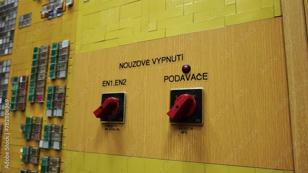 Indoor power plant control room with button panel on wall with writings ...