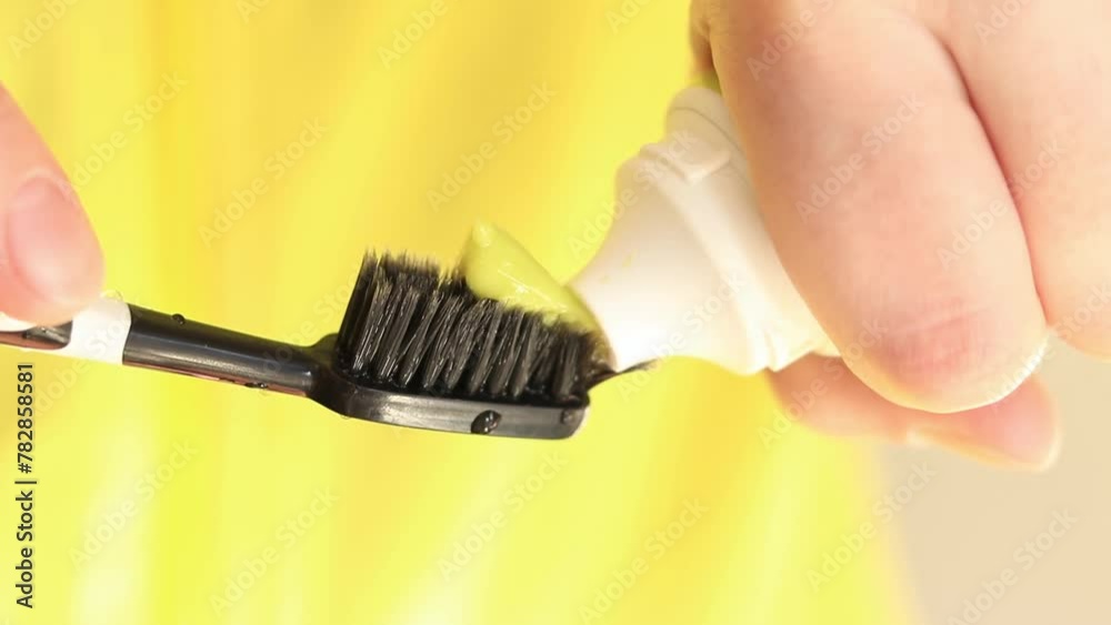 Squeezing toothpaste onto a toothbrush, close-up. Brushing your teeth ...
