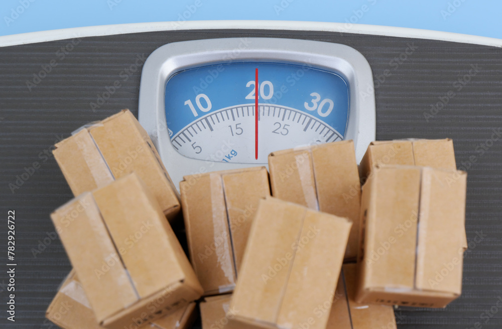 Shipping carton boxes on scale. Scale shows 20 kg. Checking weight of ...