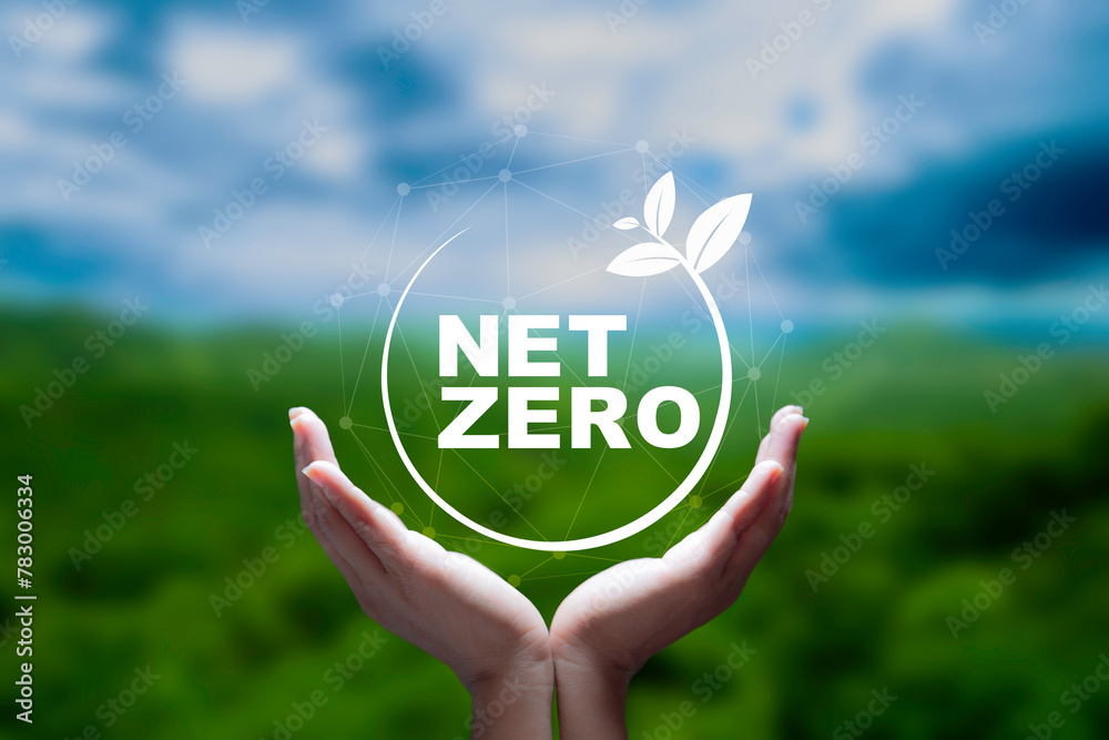 Net zero, carbon neutrality concept. Net zero icon at on hand green blur background. Green ...