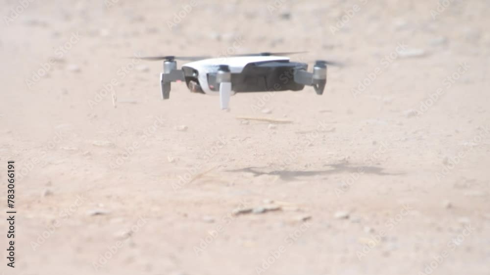 Slow motion cinematic video of a drone taking off in the desert. The ...