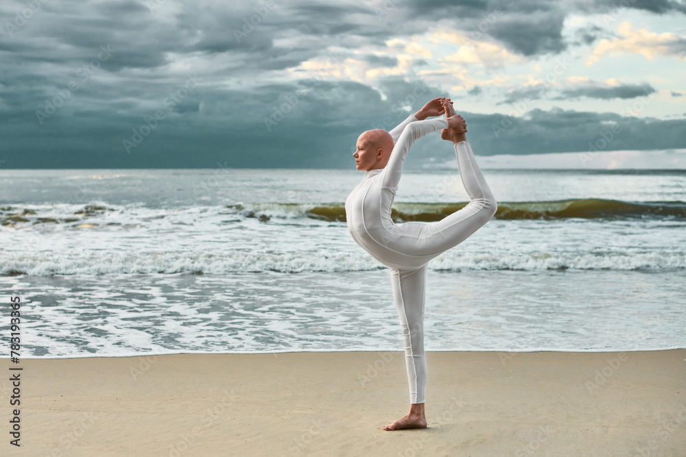 Young hairless ballerina with alopecia in white futuristic suit dancing ...