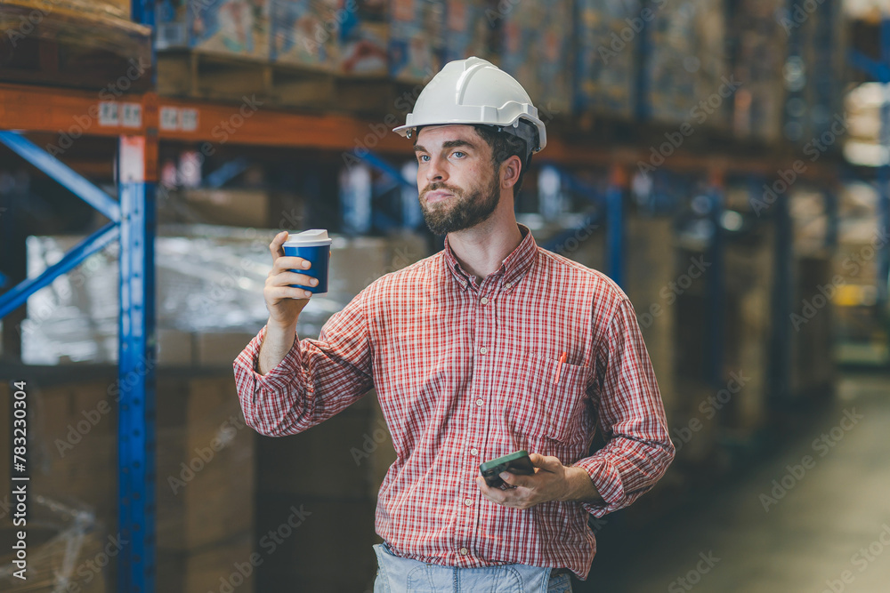 Happy worker having a coffee break in Warehouse. Warehouse worker ...