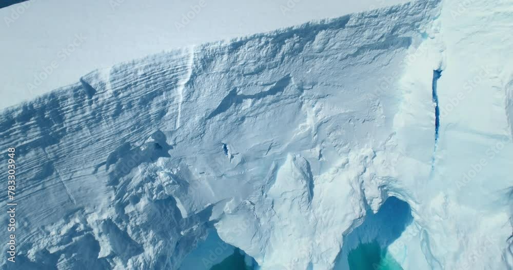 Giant ice wall melting in arctic water aerial shot. Antarctica iceberg ...