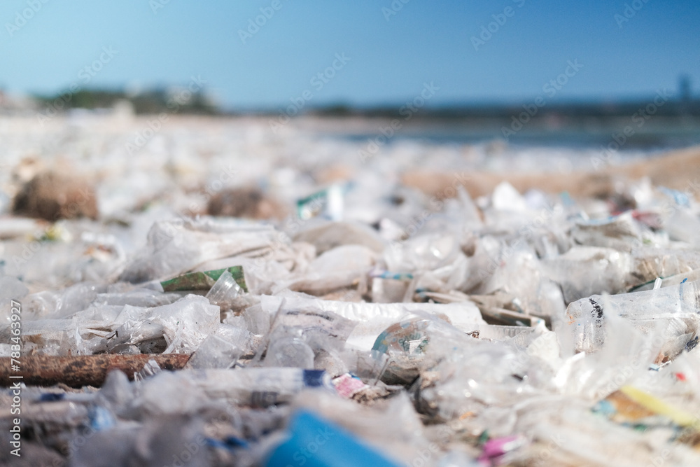 Close-up of a beach polluted with plastic waste. Global environmental ...