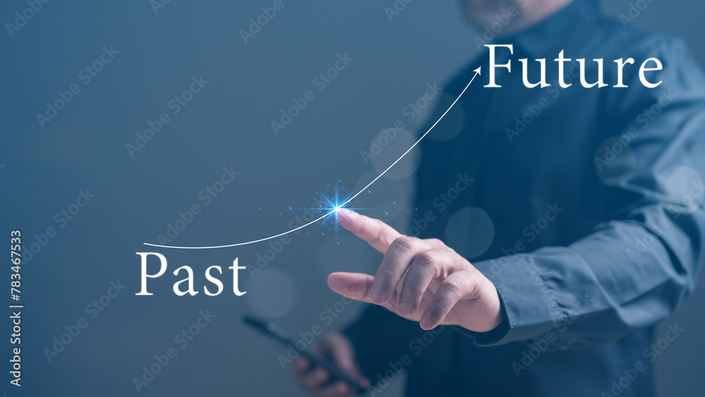 A businessman is pointing at a graph that shows a line going up and ...