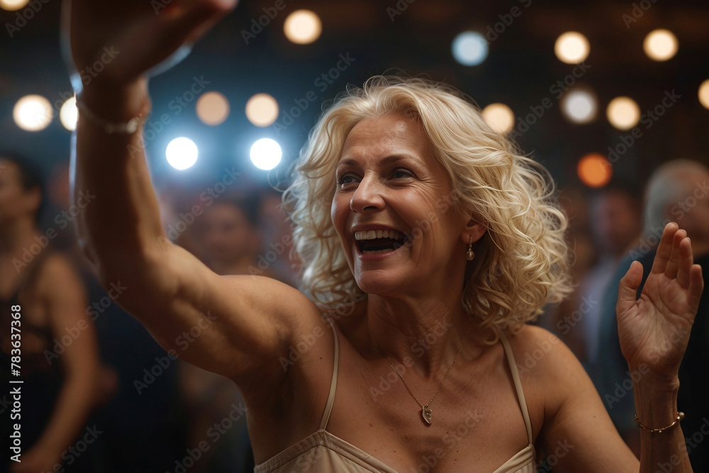Zdjęcie Stock: A happy senior aged woman dancing in a club, enjoying ...