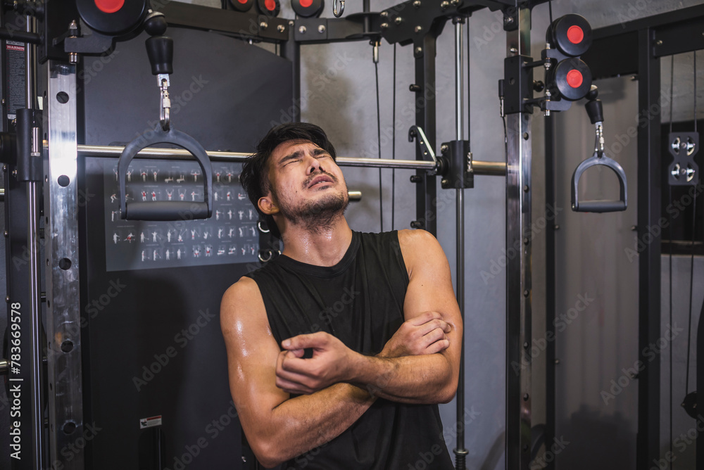 A man in extreme pain clutches his arm. Suffering from a partial or ...