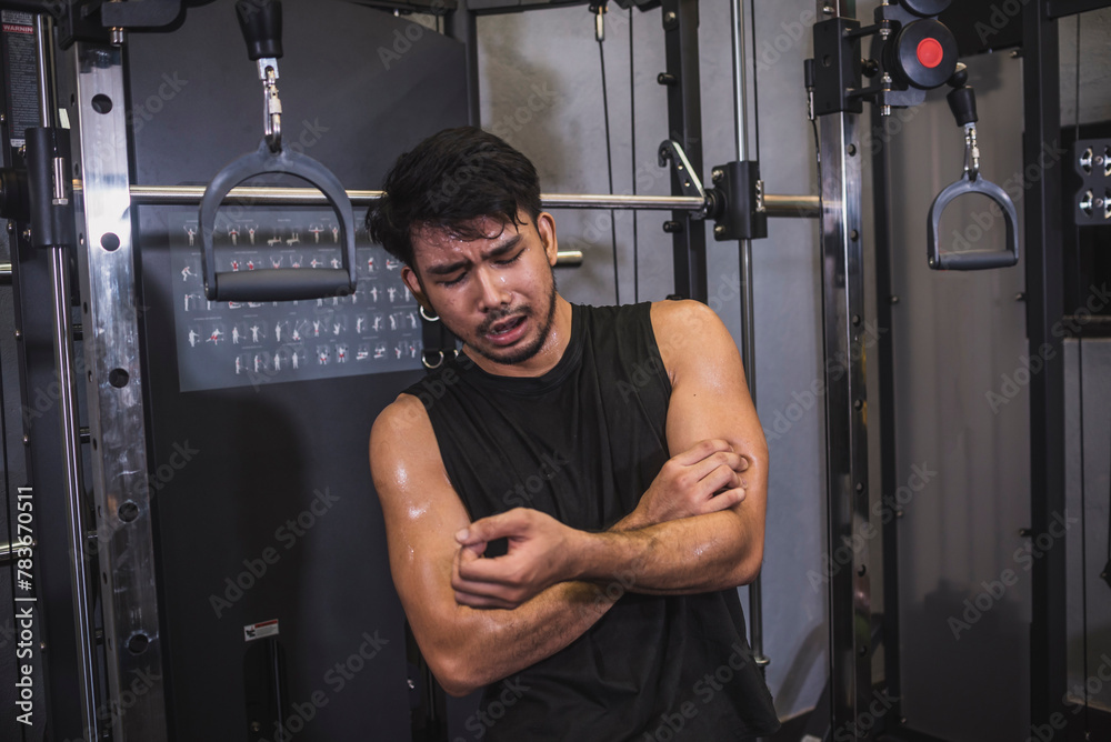A man in extreme pain clutches his arm. Suffering from a partial or ...