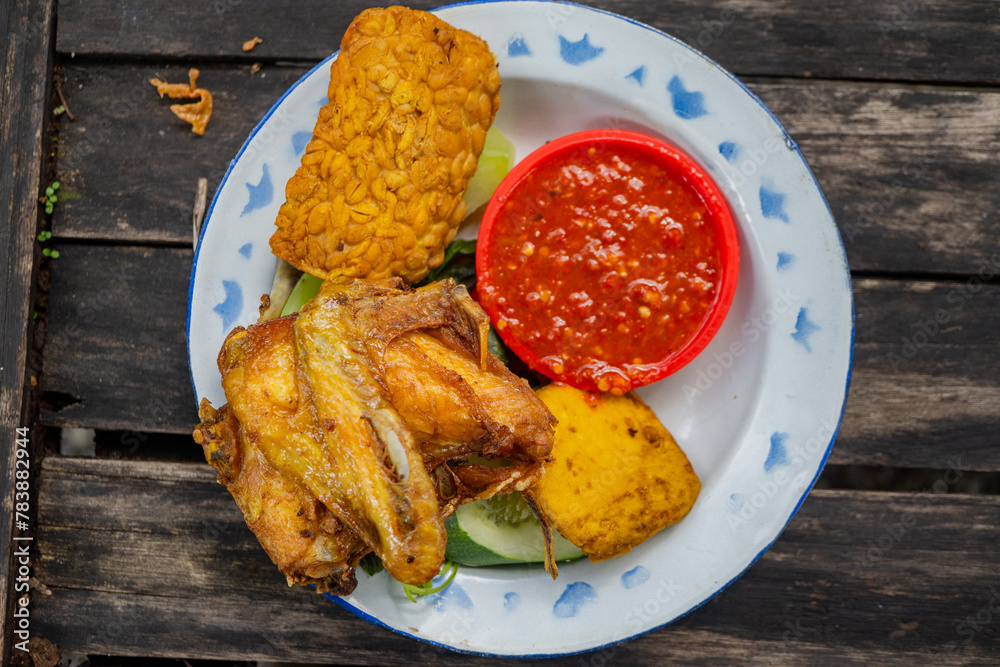 Traditional food of Javanese chicken, tofu, tempe and chili sauce. The ...