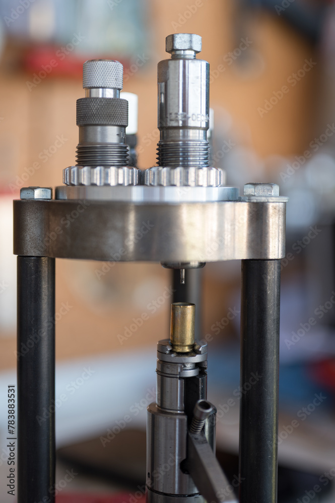 Detail of the decapping and resizing process of a 9mm case in the ...