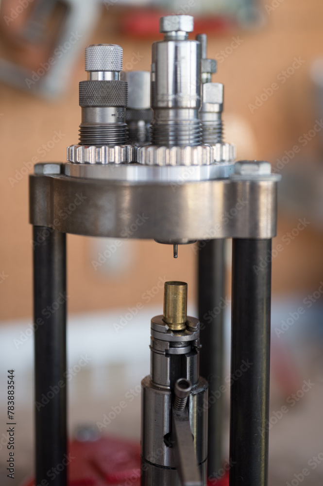 Detail of the decapping and resizing process of a 9mm case in the ...