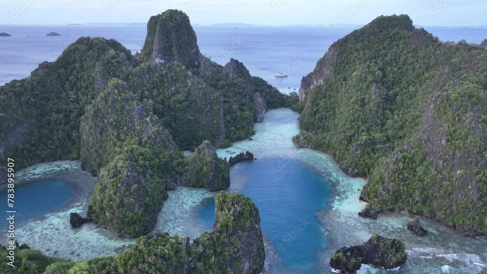 Healthy coral reefs surround rugged islands rising from Raja Ampat's ...