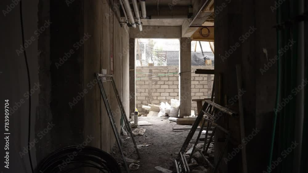 Construction site corridor with electrical fittings, pipes and ...