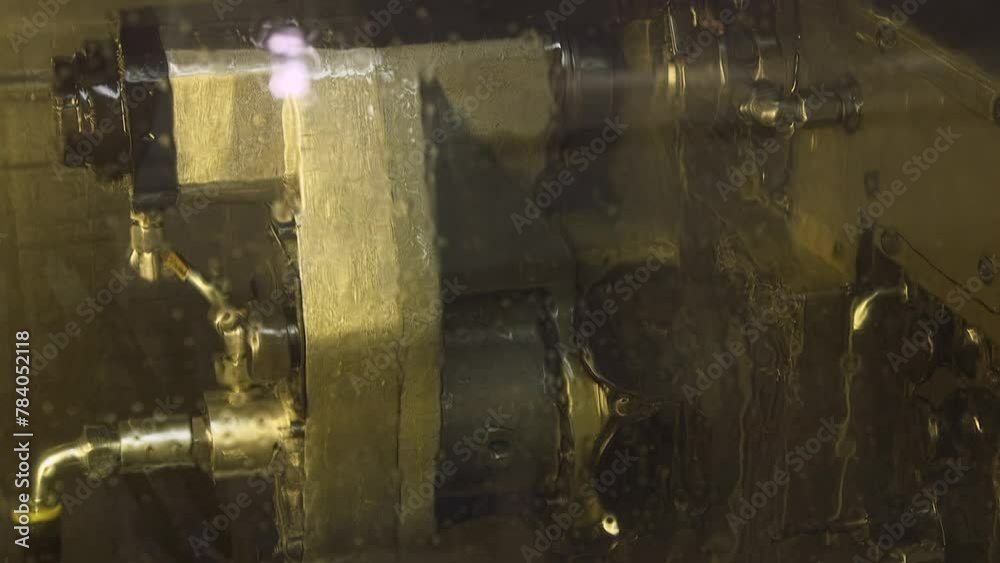 Automated lathe machine is operating at the industrial production plant ...