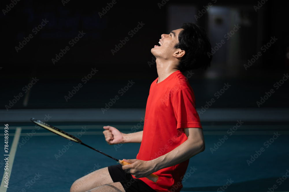 Badminton player celebrating victory on winning the game holding a ...